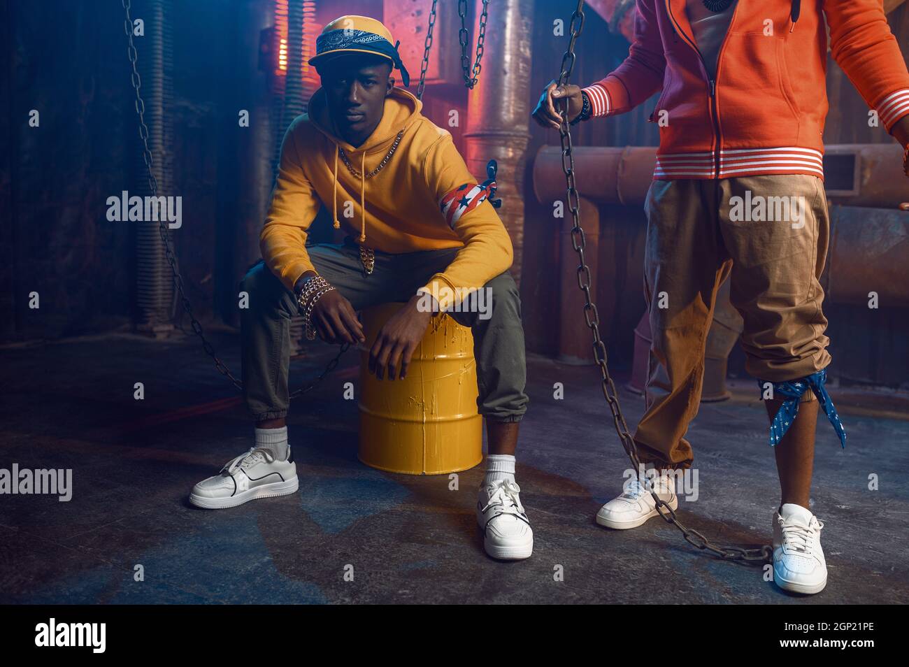 Two stylish rappers poses in studio with cool underground decoration ...