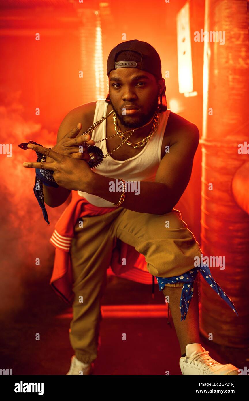 Stylish rapper shows his gold jewelry in studio with cool underground ...