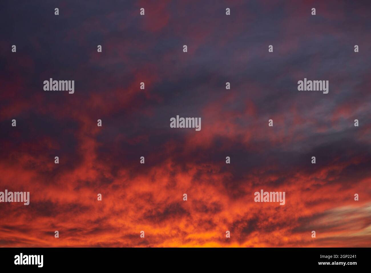 Sunset. Heaven, orange sky. Sun rays. Wallpaper. Clouds Stock Photo - Alamy