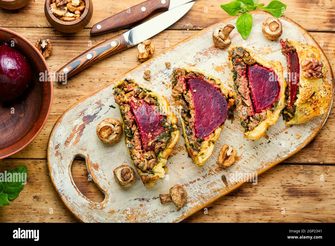 Delicious beetroot pie sliced on a kitchen board.Wellington pie Stock ...