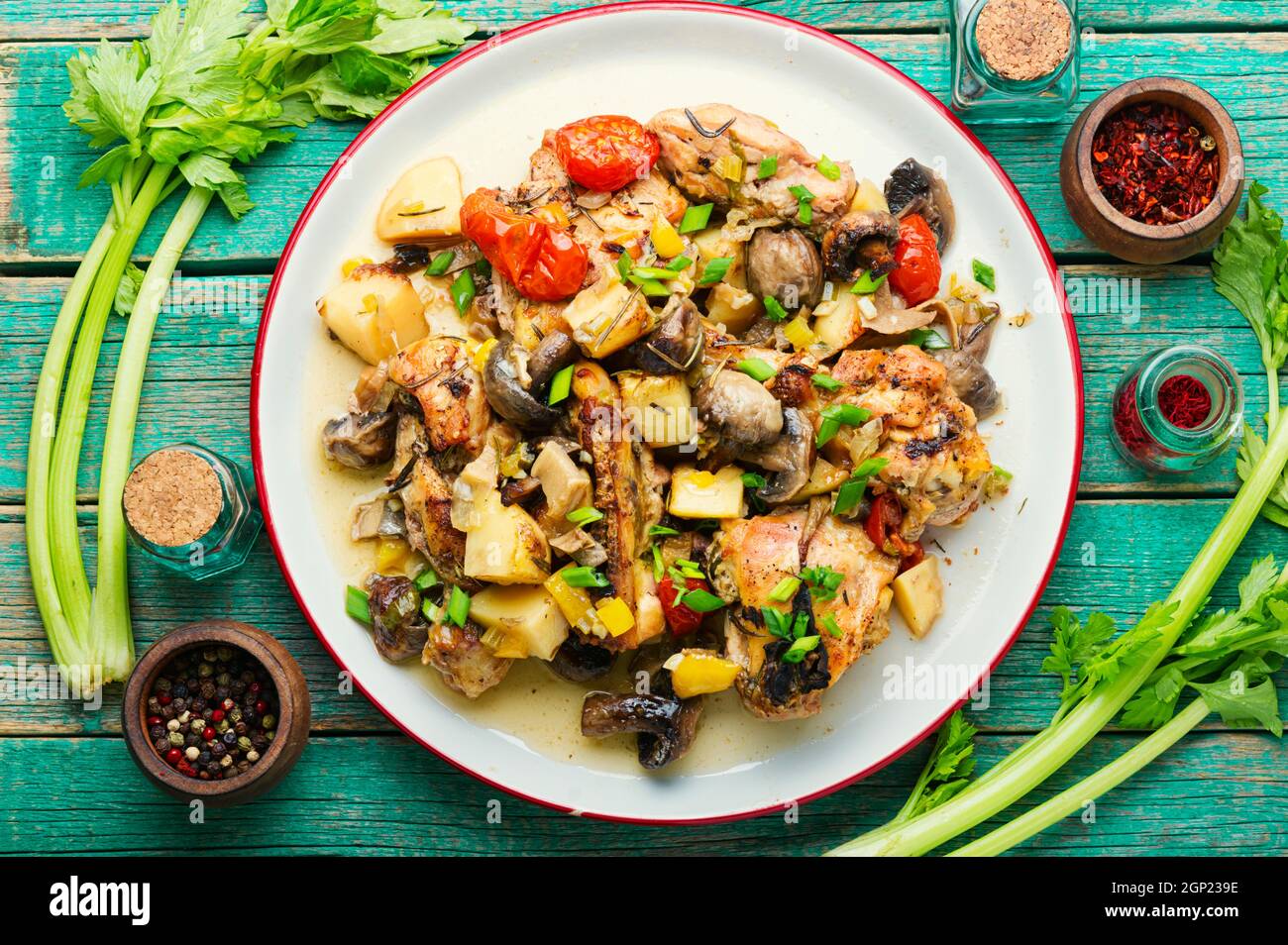 Tasty stew or ragout with chicken meat and vegetables on old wooden ...