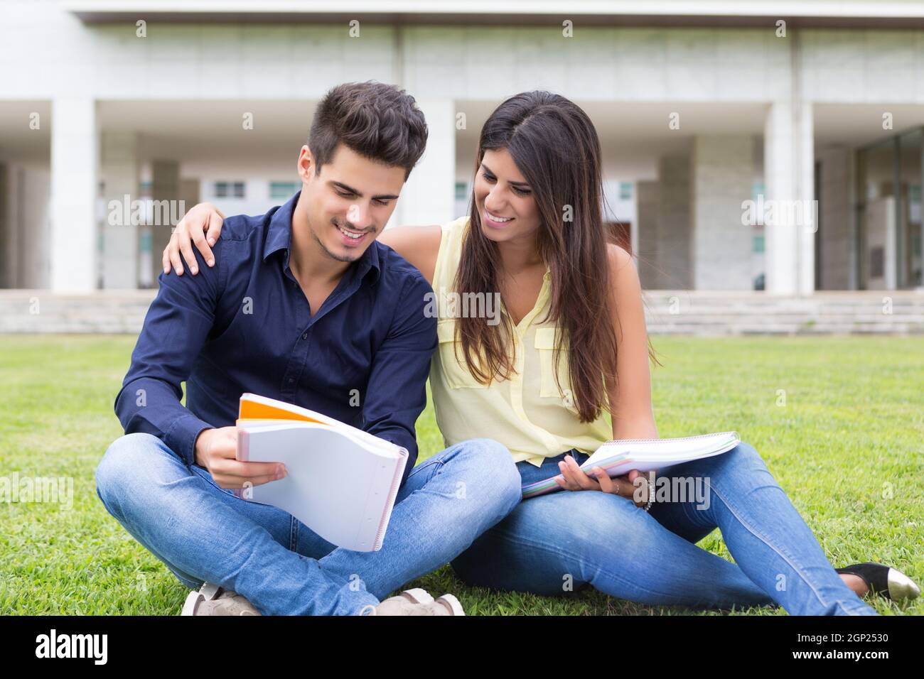 Couple of happy students at the university campus Stock Photo - Alamy