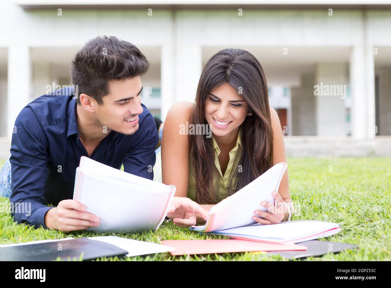 Couple of happy students at the university campus Stock Photo - Alamy