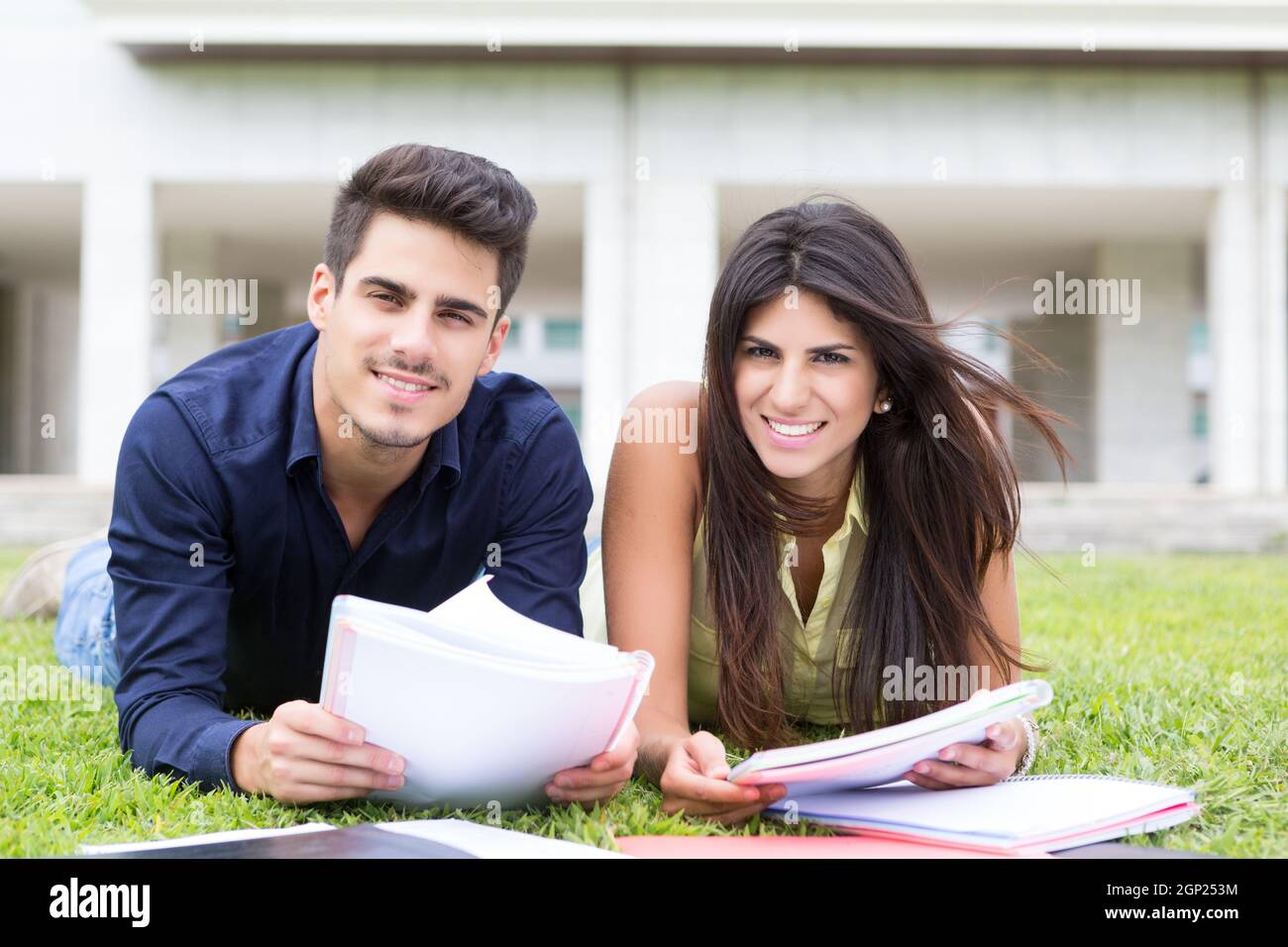 Couple of happy students at the university campus Stock Photo - Alamy