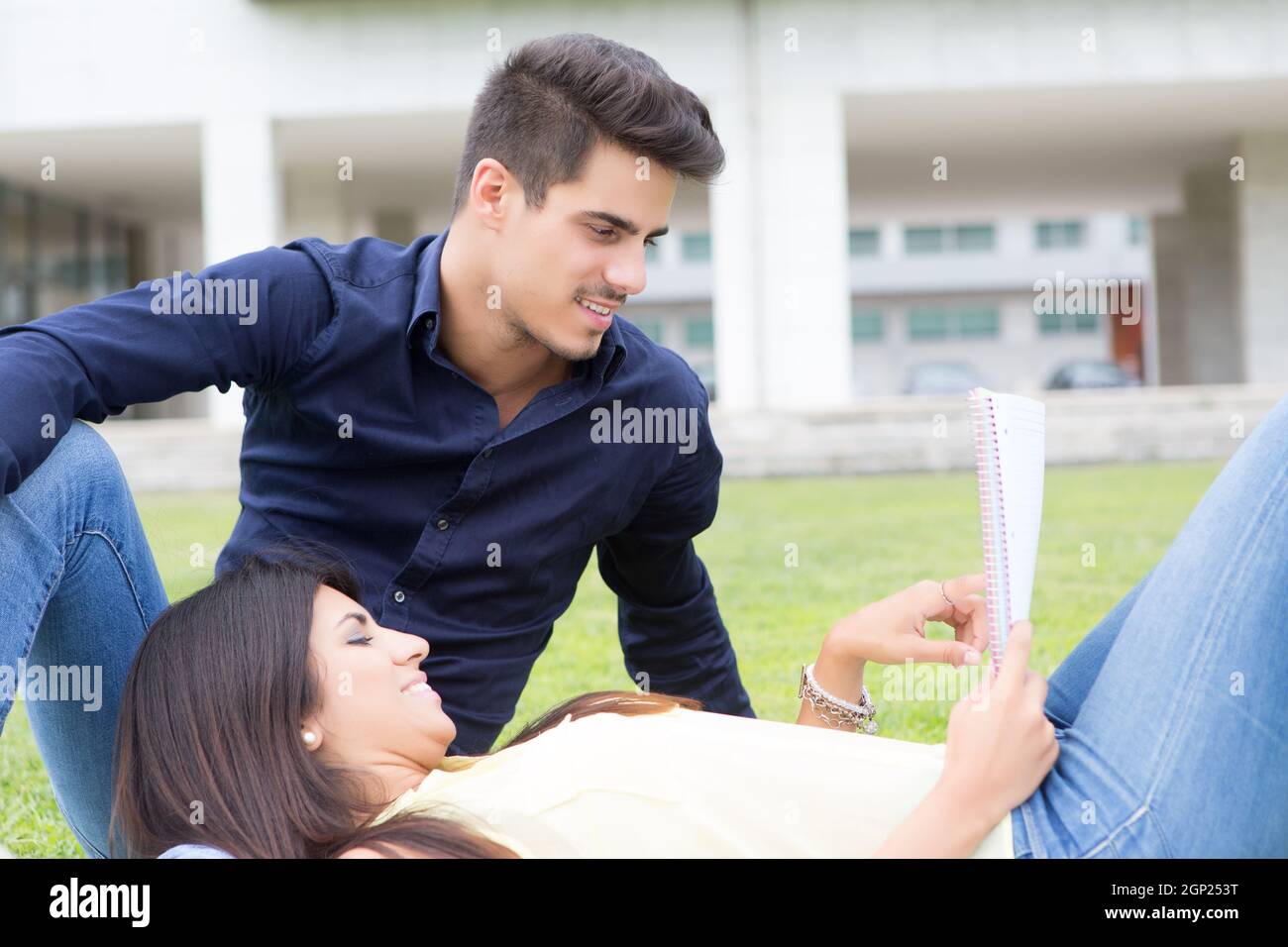 Couple of happy students at the university campus Stock Photo - Alamy