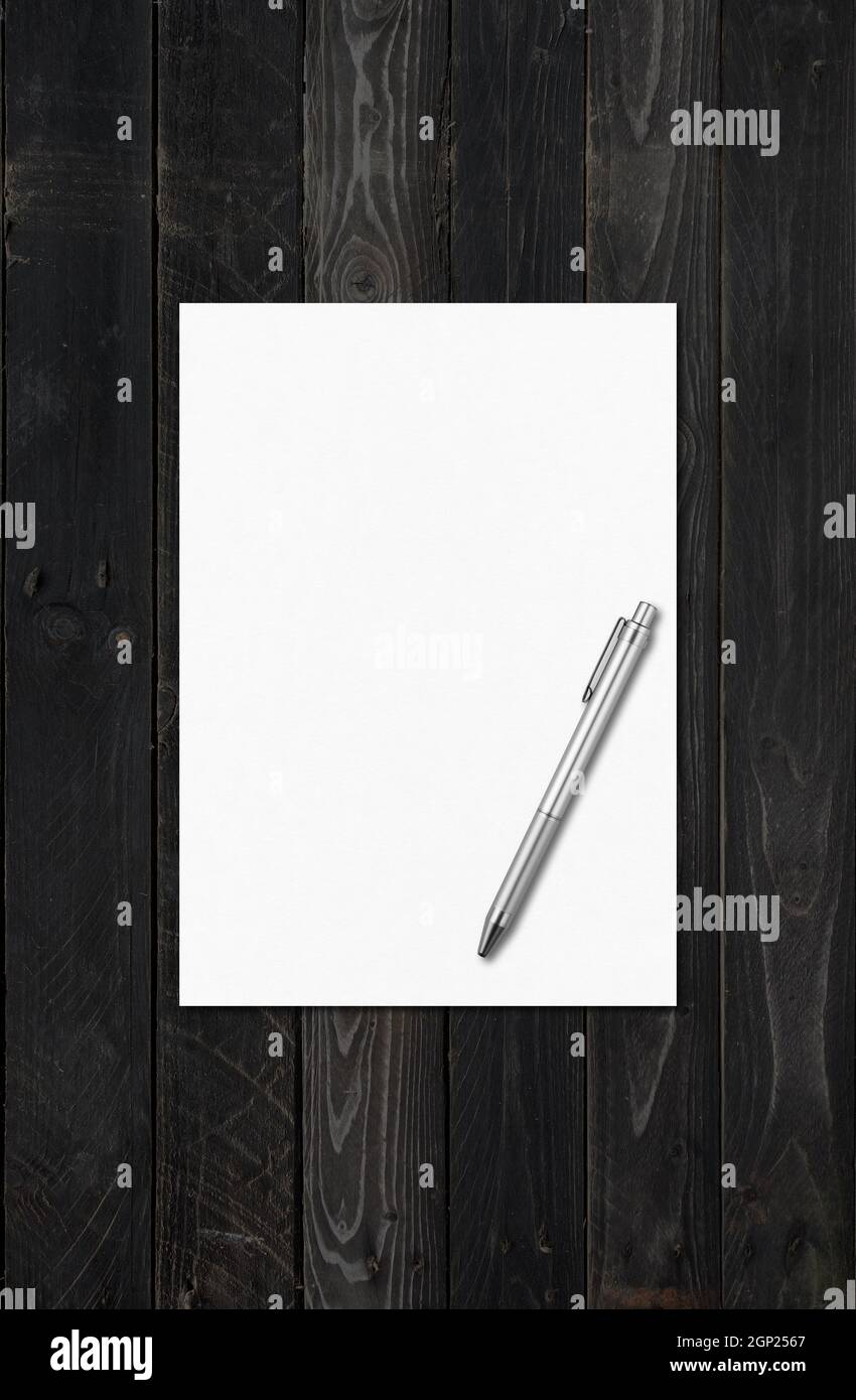 Blank A4 paper sheet and pen mockup template isolated on black wood ...