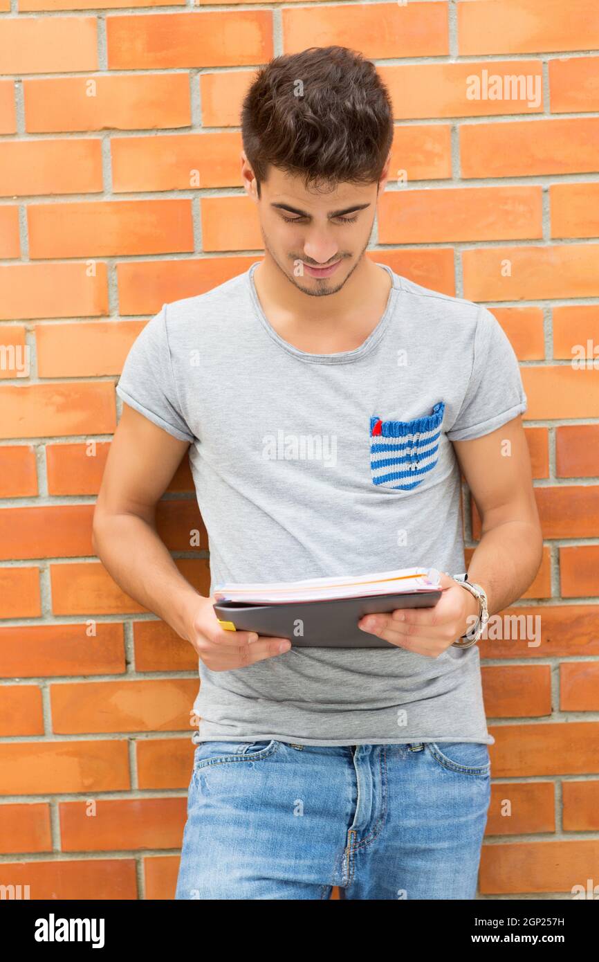 Happy student relaxing at the university campus Stock Photo - Alamy