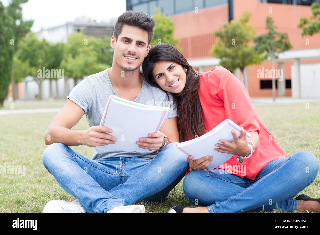Couple of happy students at the university campus Stock Photo - Alamy