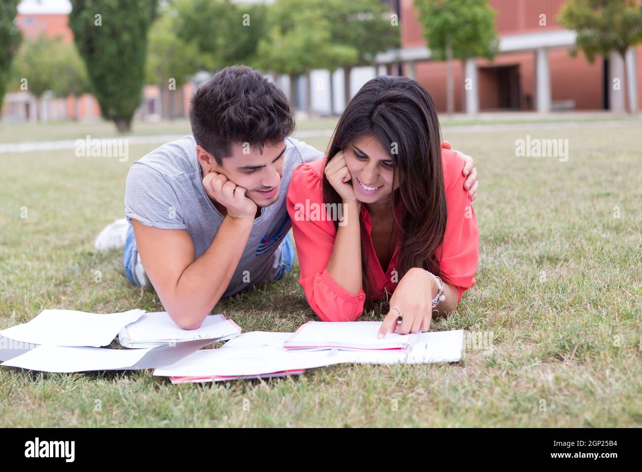 Couple of happy students at the university campus Stock Photo - Alamy