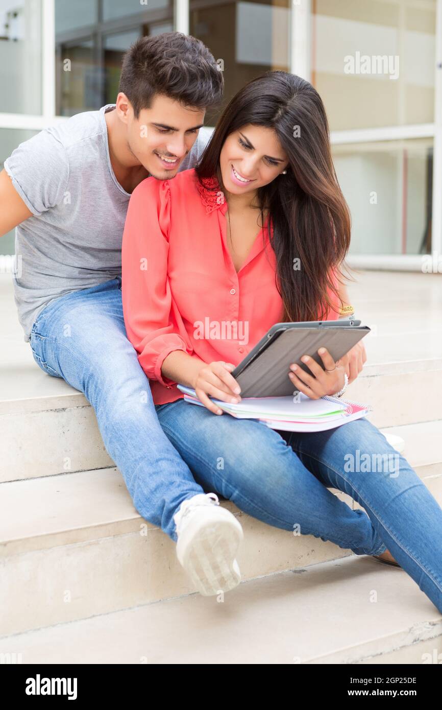 Couple of happy students at the university campus Stock Photo - Alamy