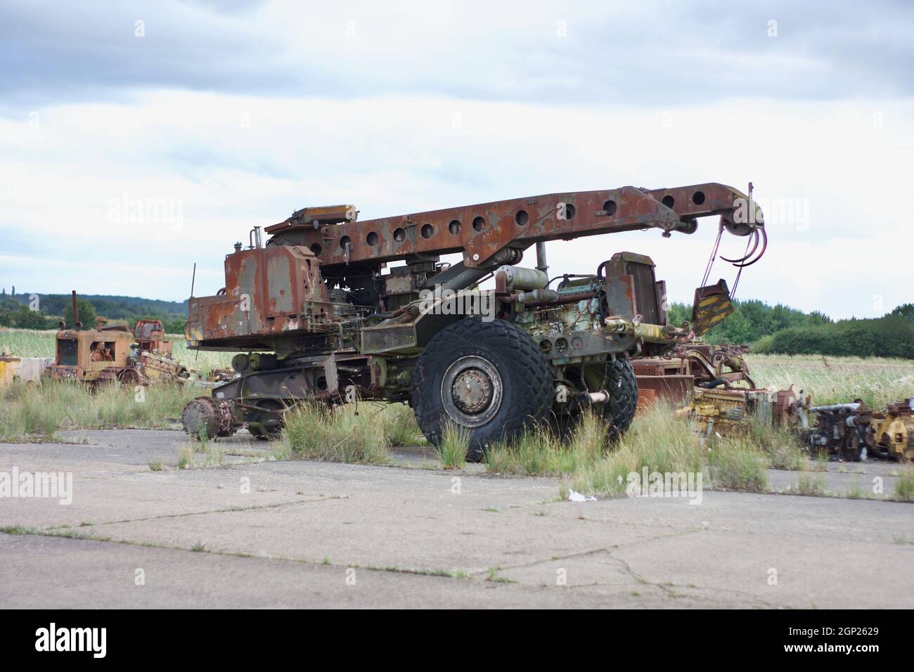 Abandoned construction vehicles parked up on a disused runway in ...