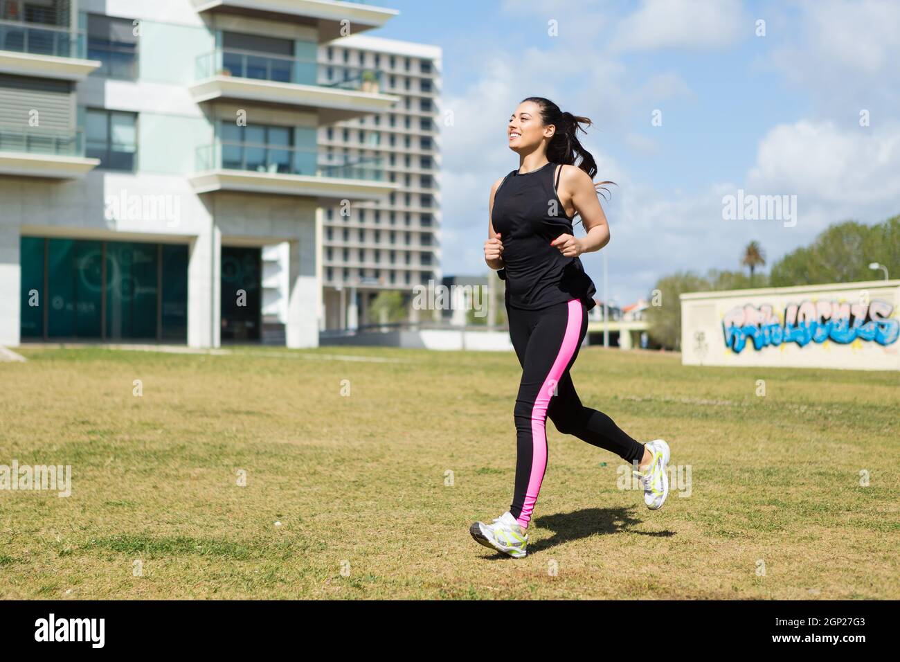 A beautiful young woman making some exercise at the park - fitness ...