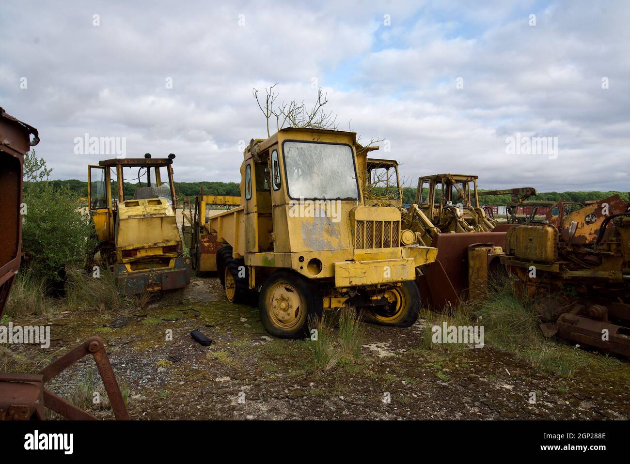 Abandoned construction vehicles parked up on a disused runway in ...