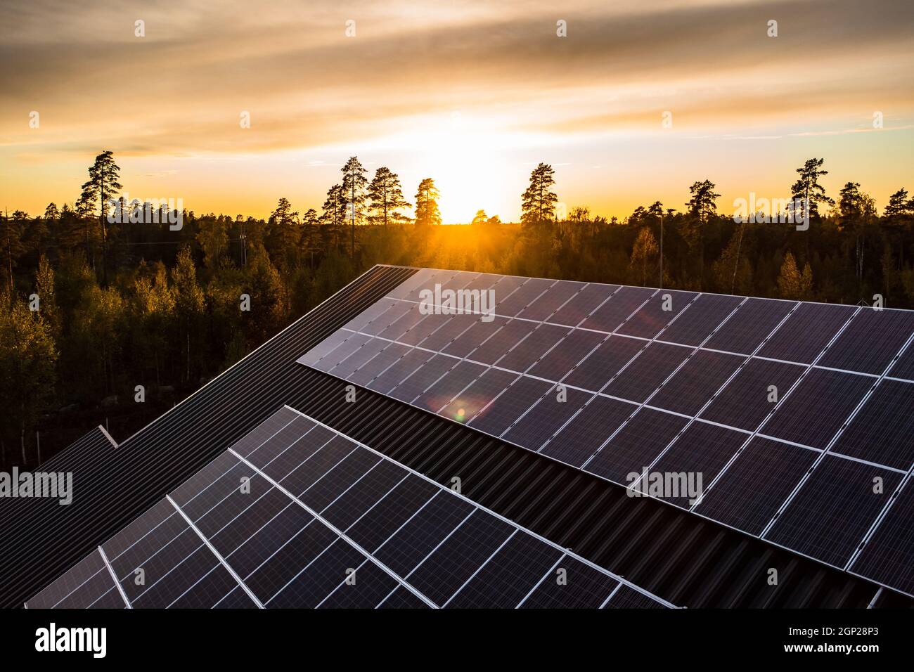 roof solar cells, sunset forest background 01 Stock Photo - Alamy