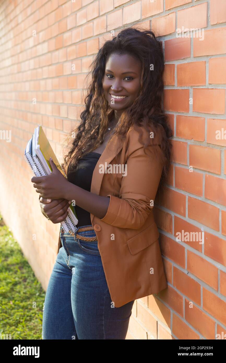 Happy student relaxing at the university campus Stock Photo - Alamy