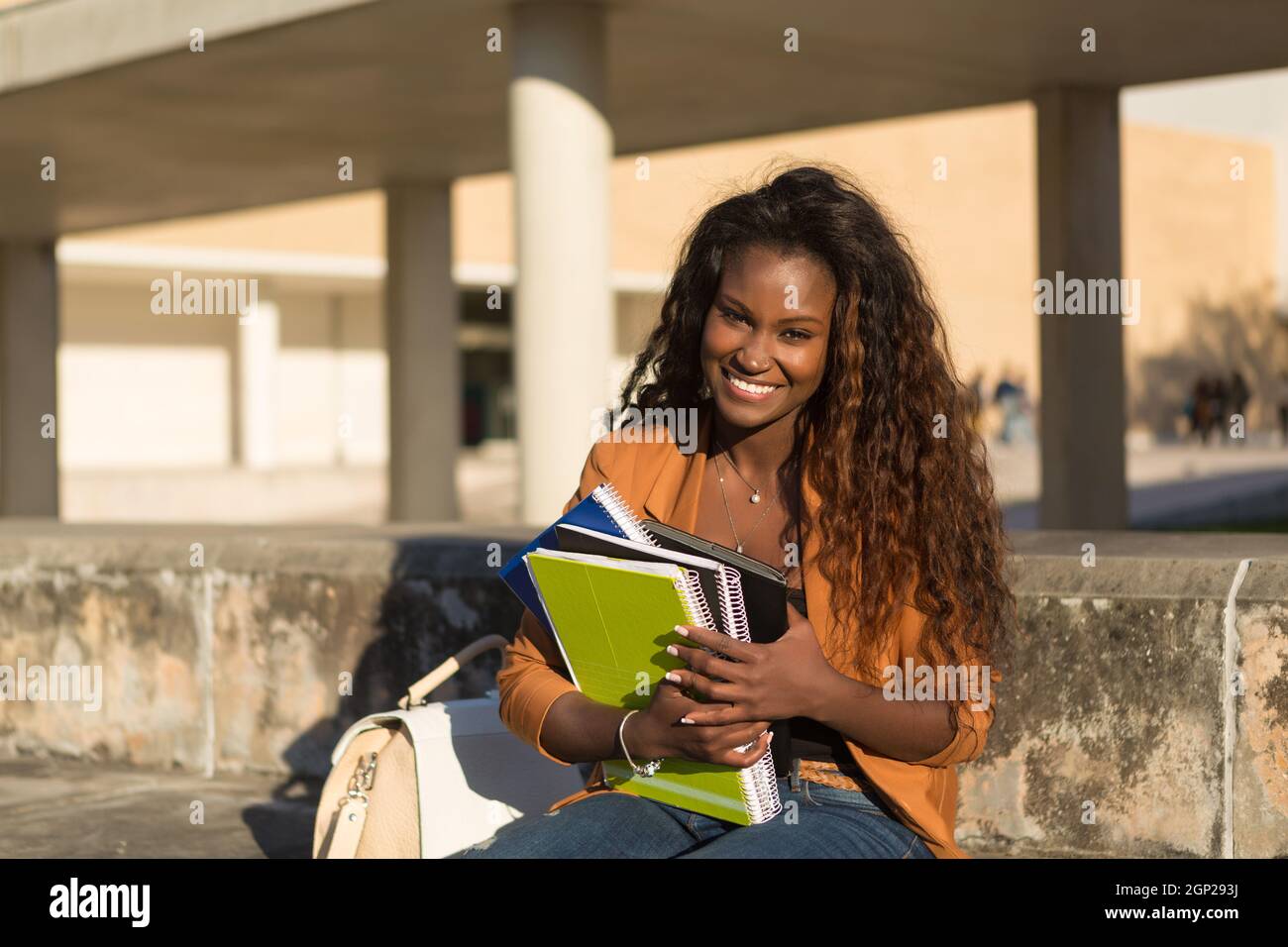 Happy student relaxing at the university campus Stock Photo - Alamy