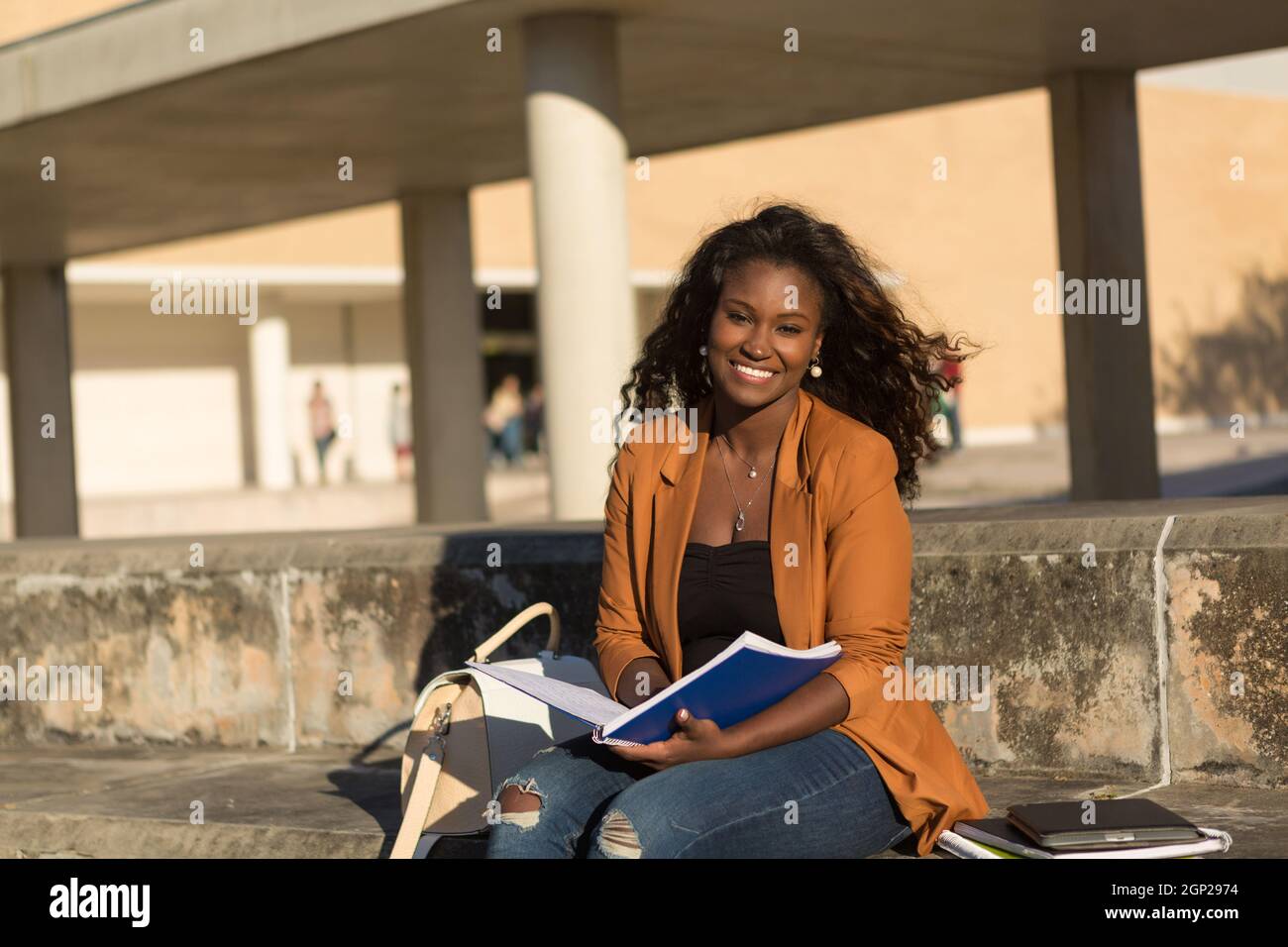 Happy student relaxing at the university campus Stock Photo - Alamy