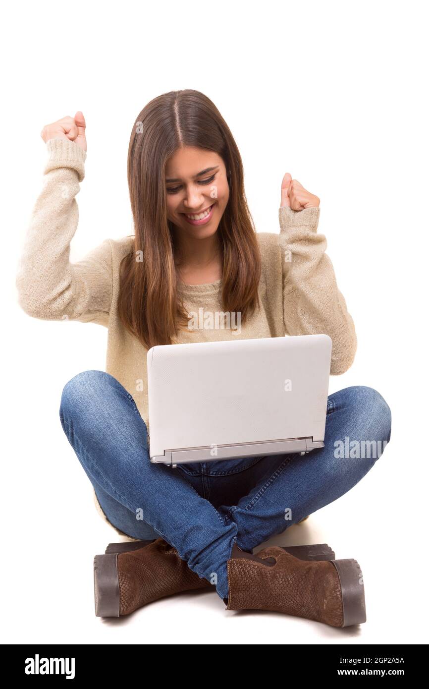 Young student working with her laptop, isolated over a white background ...