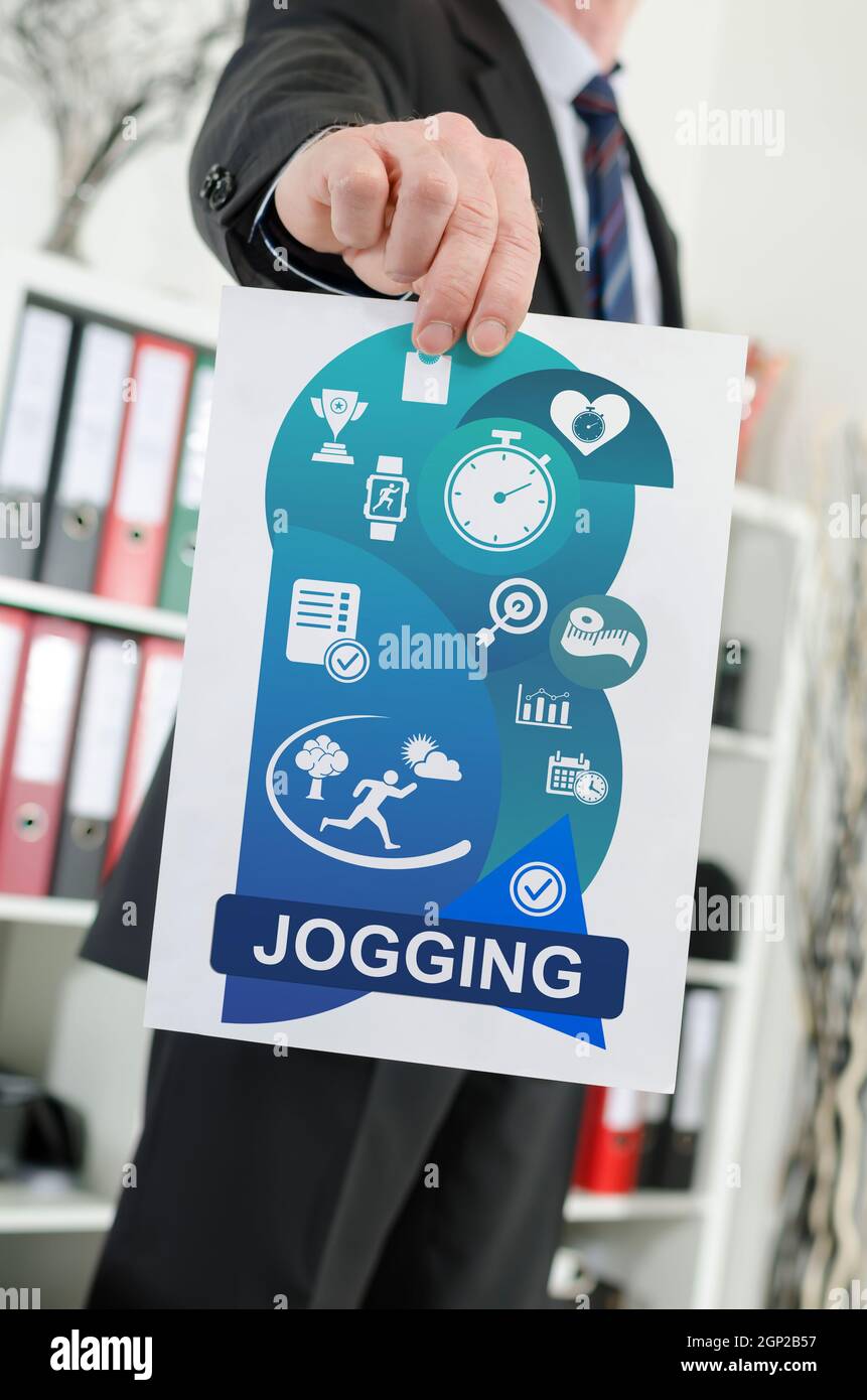 Paper showing jogging concept held by a businessman Stock Photo - Alamy
