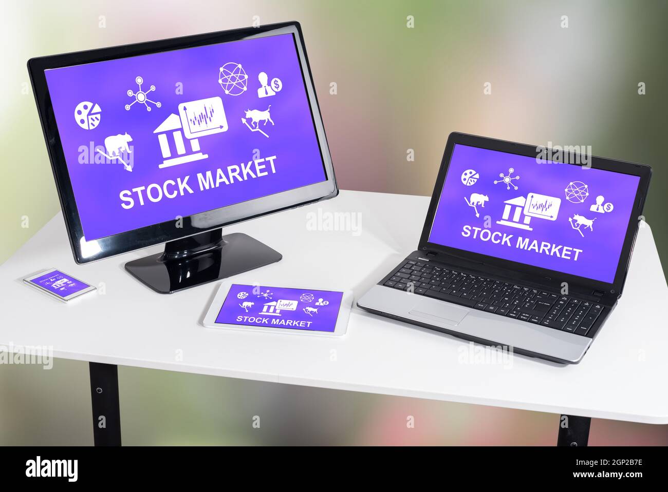 Stock market concept shown on different information technology devices ...