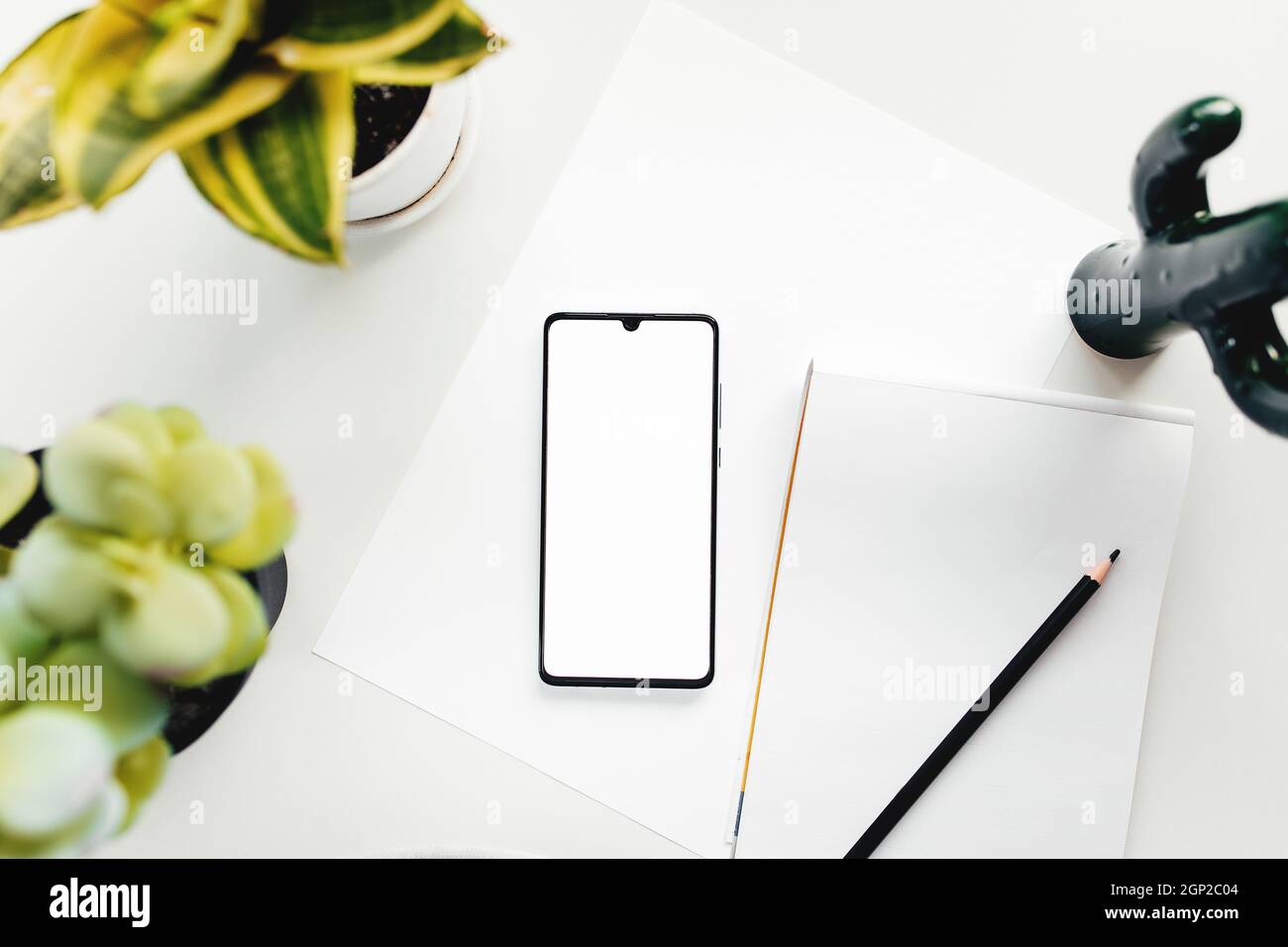 Smartphone on white table, work from home, office stuff. High quality ...