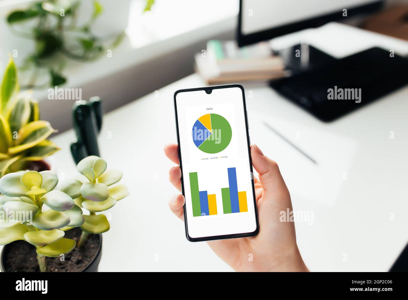 Smartphone in the hand, work from home, office stuff. High quality ...