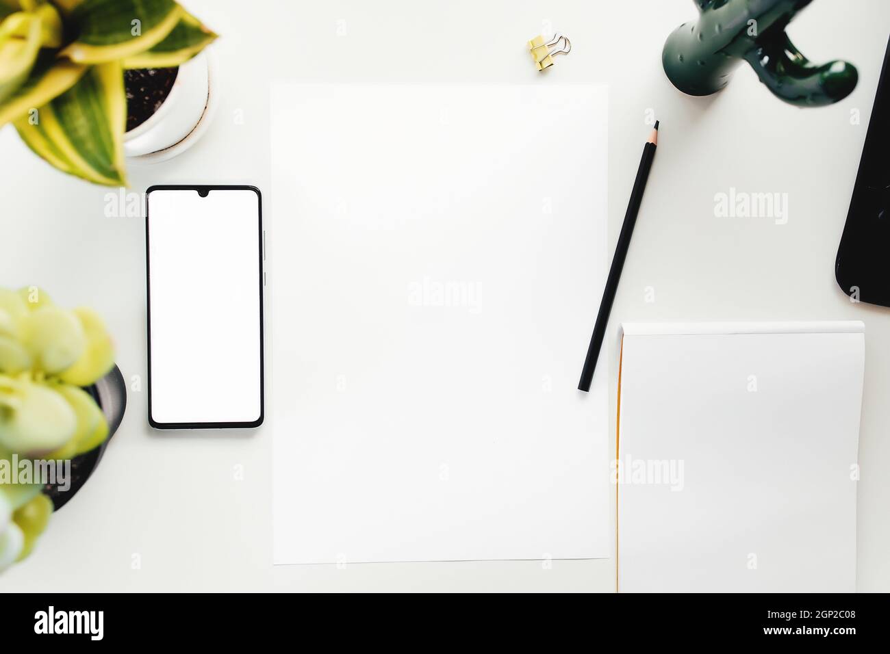 Smartphone on white table, work from home, office stuff. High quality ...