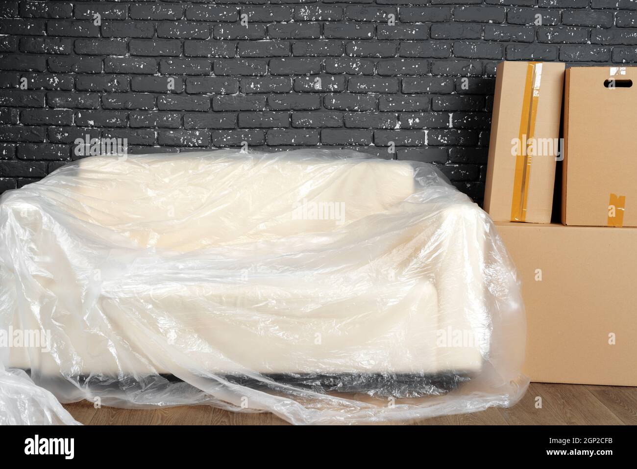 Moving in or moving out concept. Stack of boxes and packed furniture ...