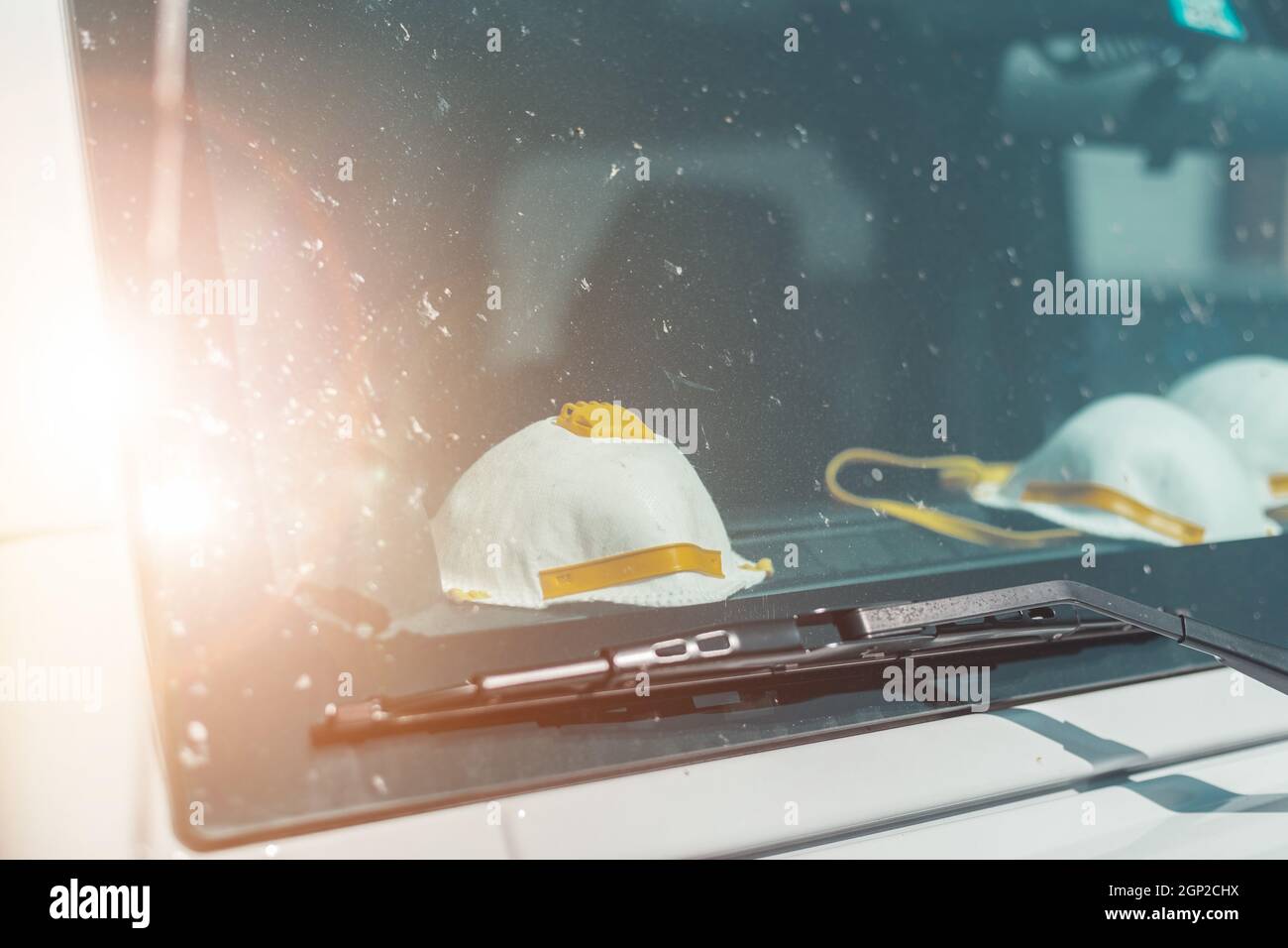 Face mask or surgical mask is lying in a car behind the front shield ...