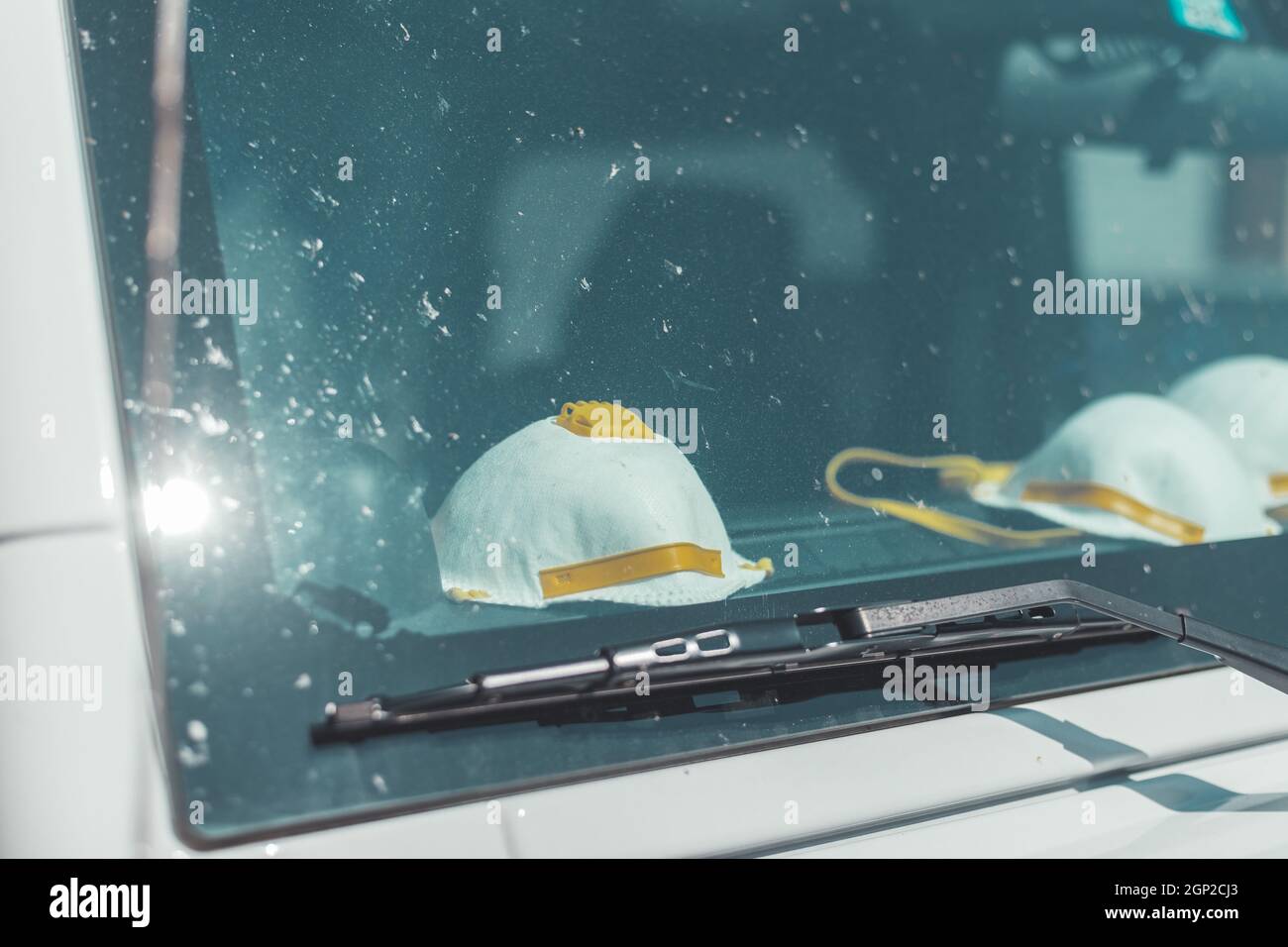 Face mask or surgical mask is lying in a car behind the front shield ...