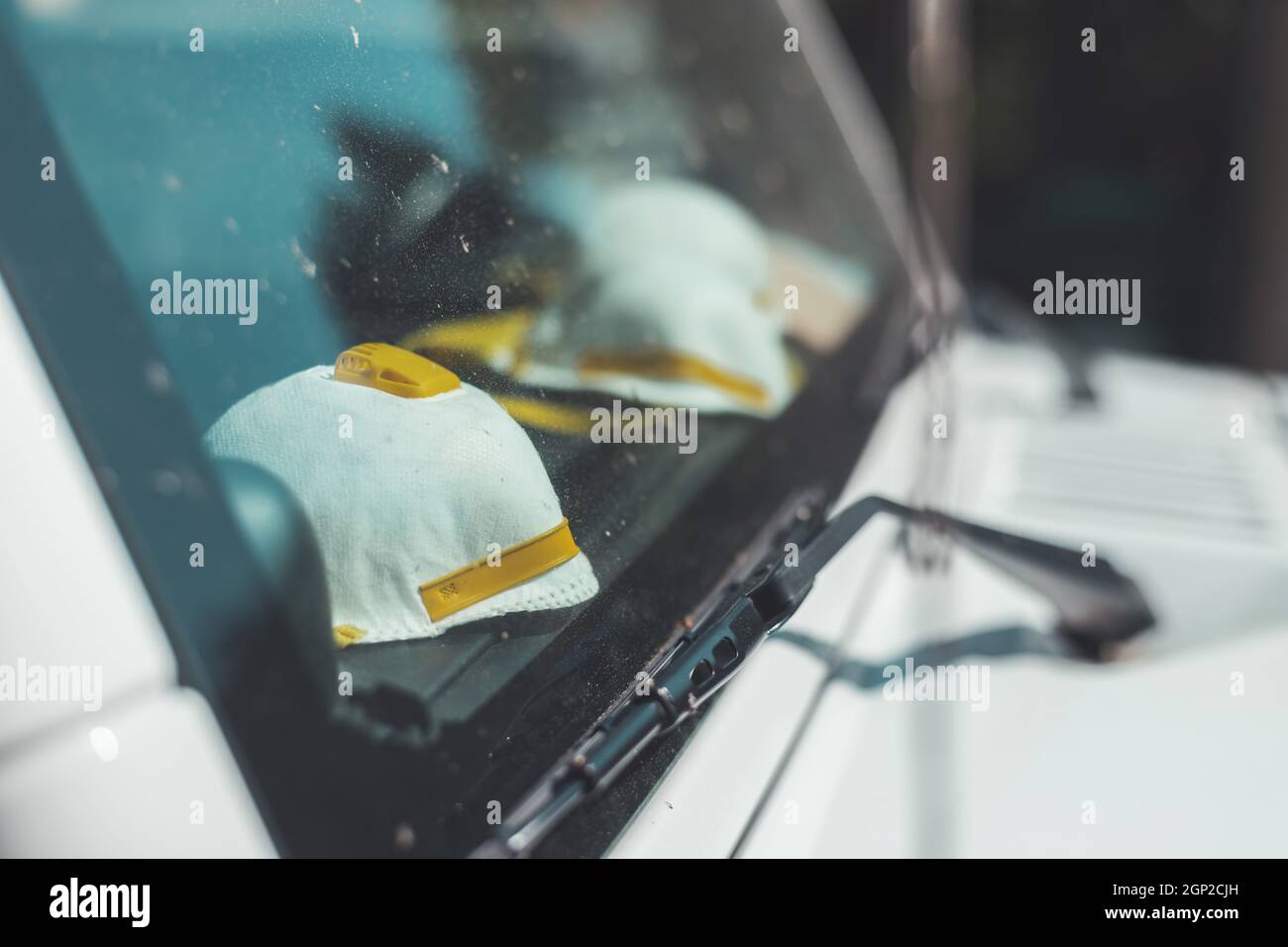 Face mask or surgical mask is lying in a car behind the front shield ...