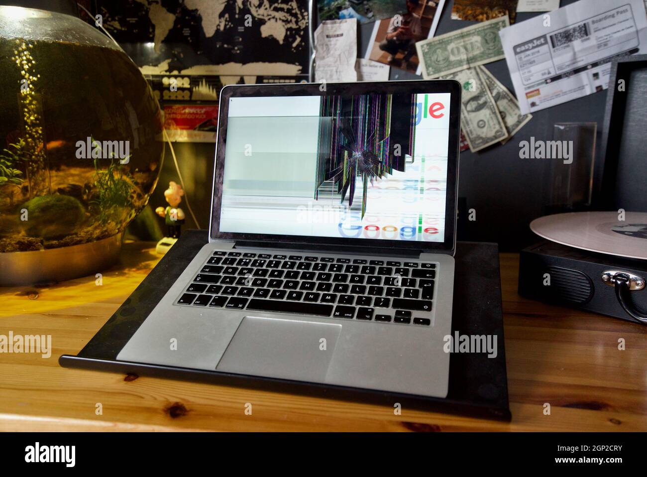 Laptop with a smashed screen (MacBook Pro, Retina 13-inch 2015) with a glitchy screen caused by ...
