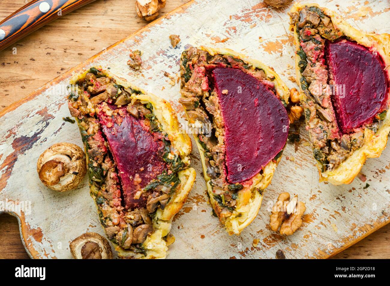 Delicious beetroot pie sliced on a kitchen board.Wellington pie Stock ...