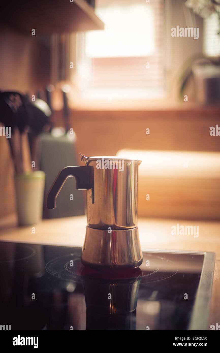 Italian coffee cooker on hot stove, breakfast Stock Photo - Alamy