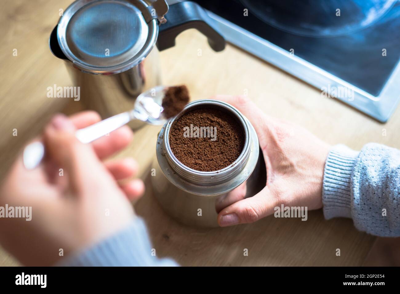 Preparing coffee: Close up of coffee powder in a vintage coffee cooker ...