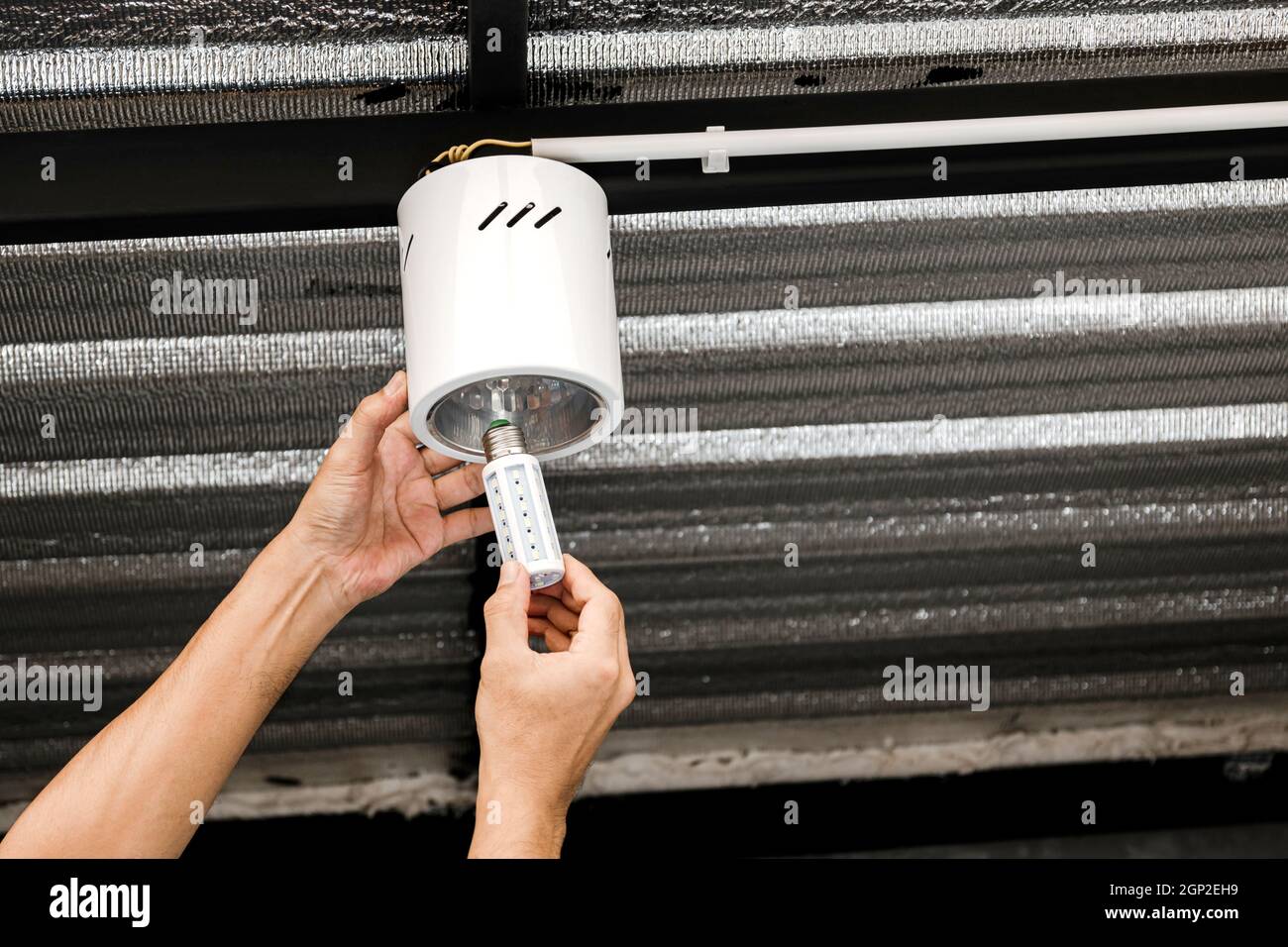 Hand installing led light bulb hi-res stock photography and images - Alamy