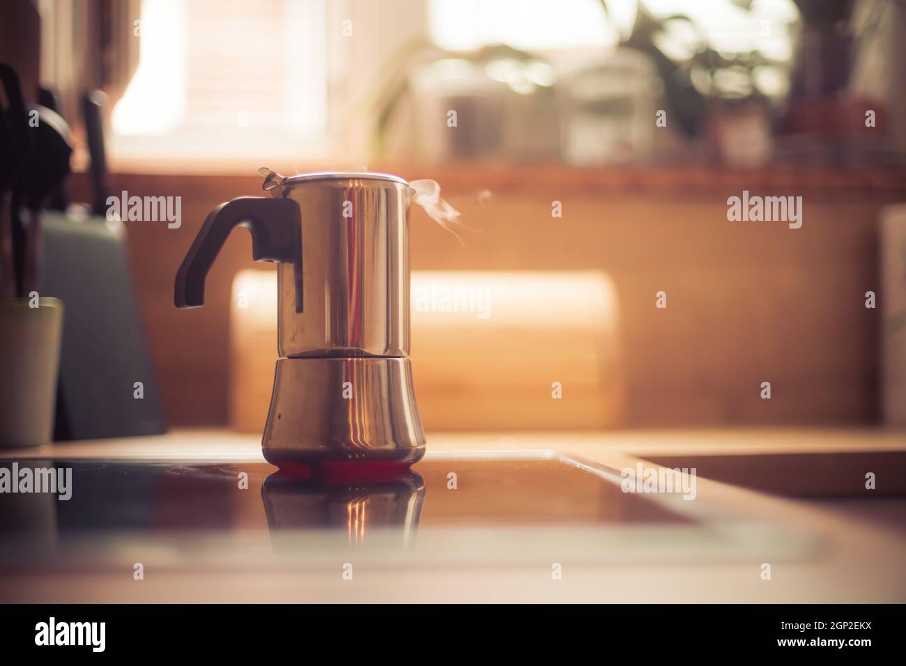 Italian coffee cooker on hot stove, breakfast Stock Photo - Alamy