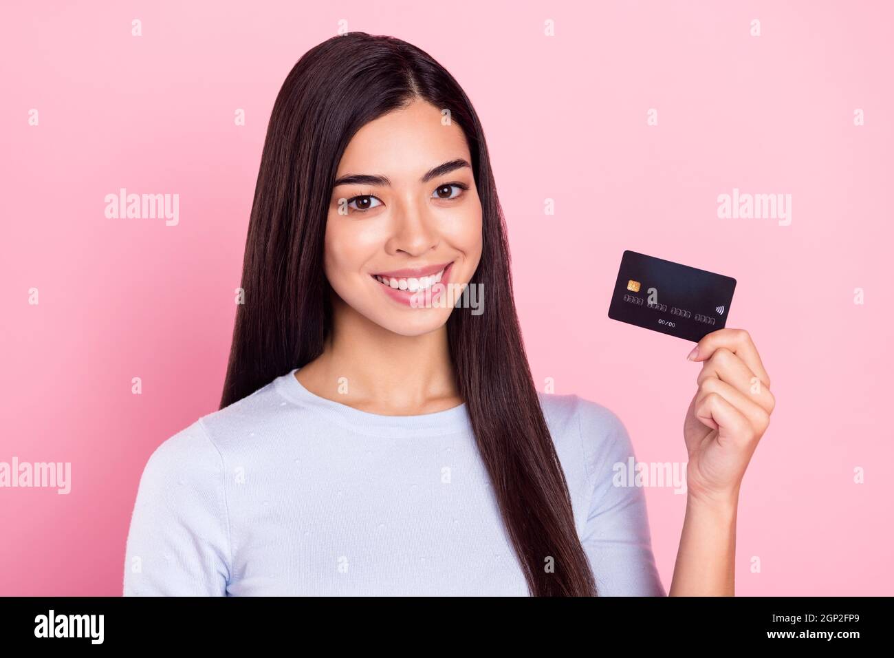 Portrait of attractive cheerful girl holding bank card order paypass ...