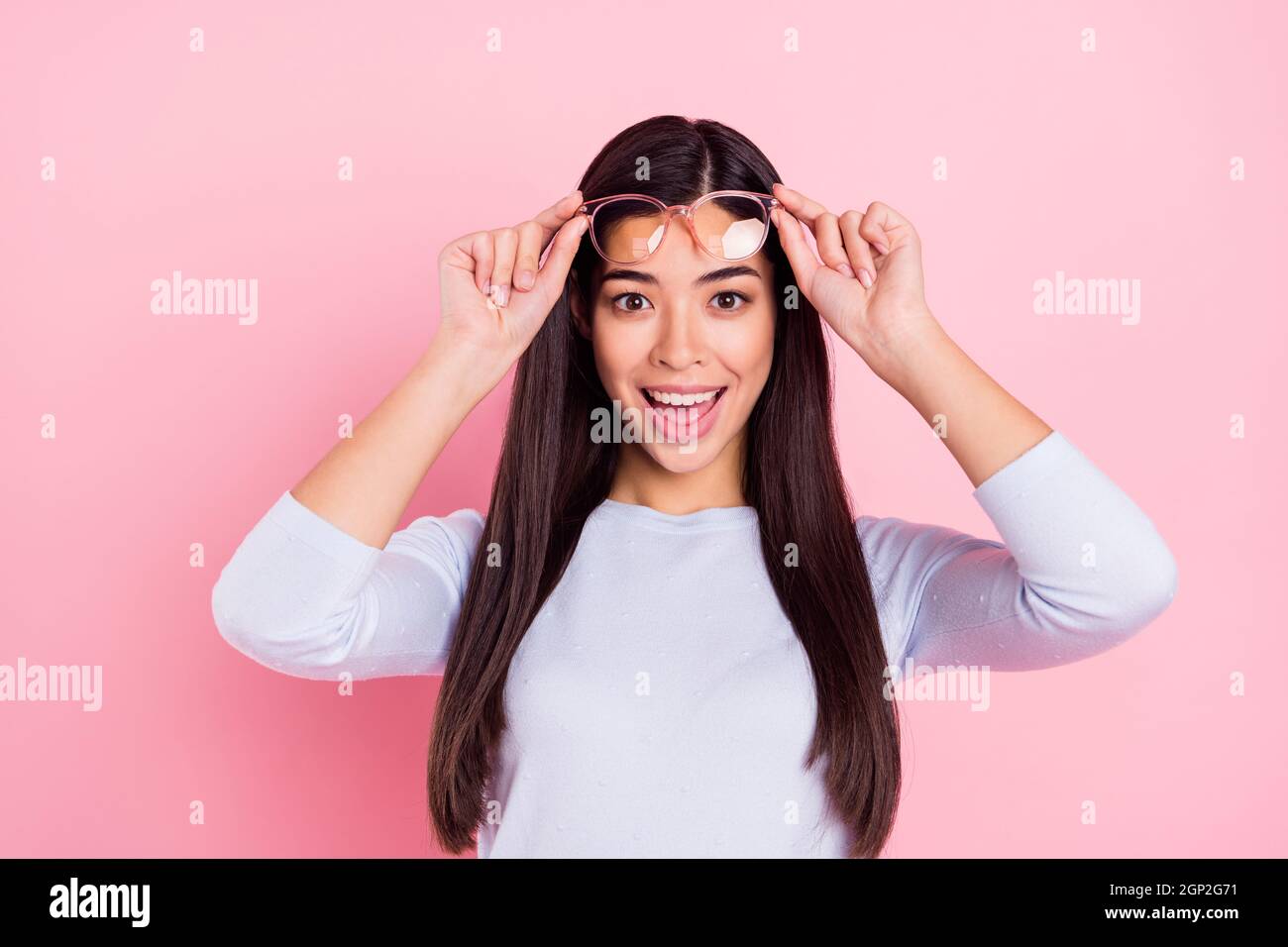 Portrait Of Attractive Amazed Cheerful Girl Touching Specs Good News
