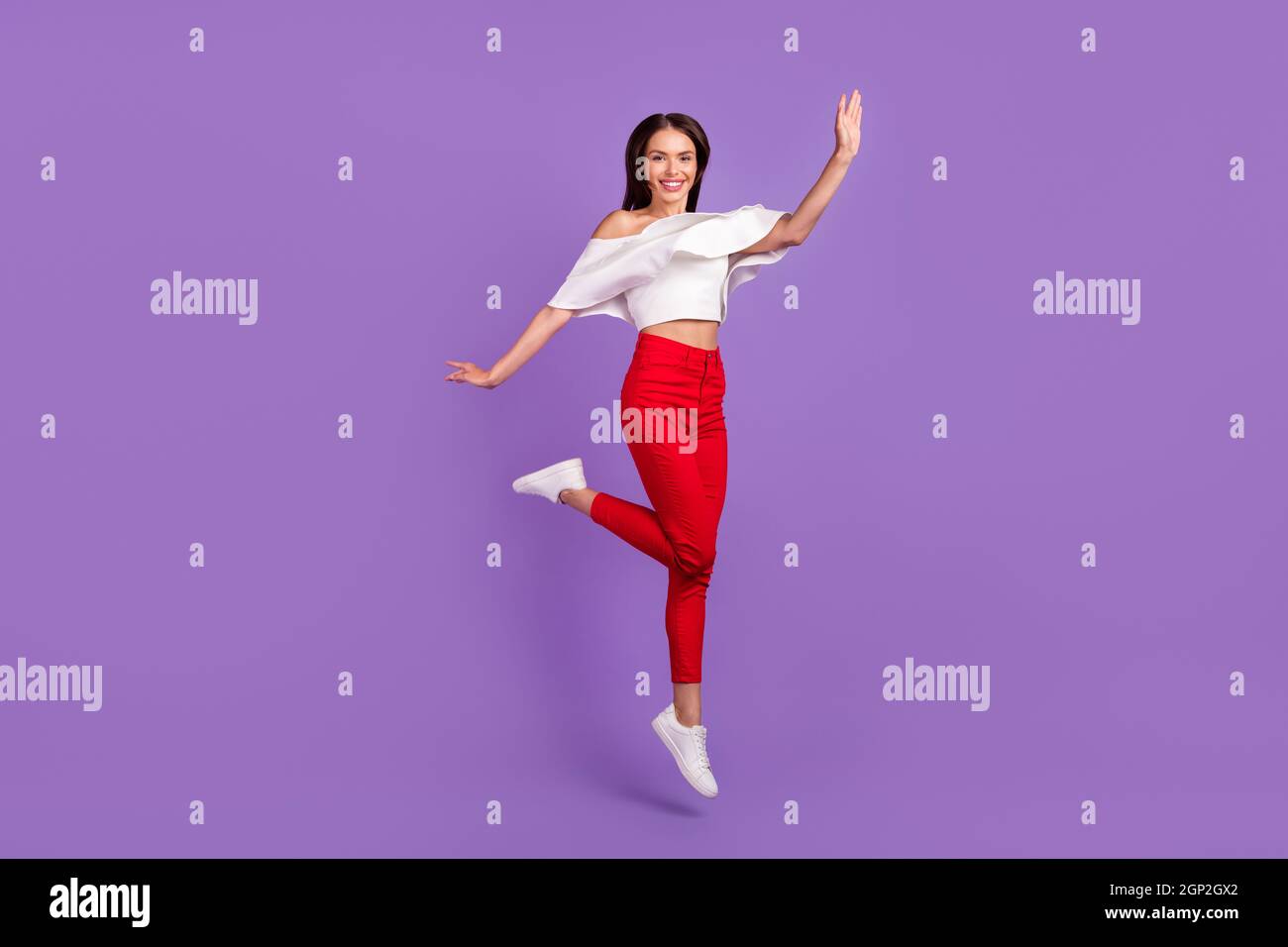Photo of cheerful sportive lady jump raise arm wear white blouse ...