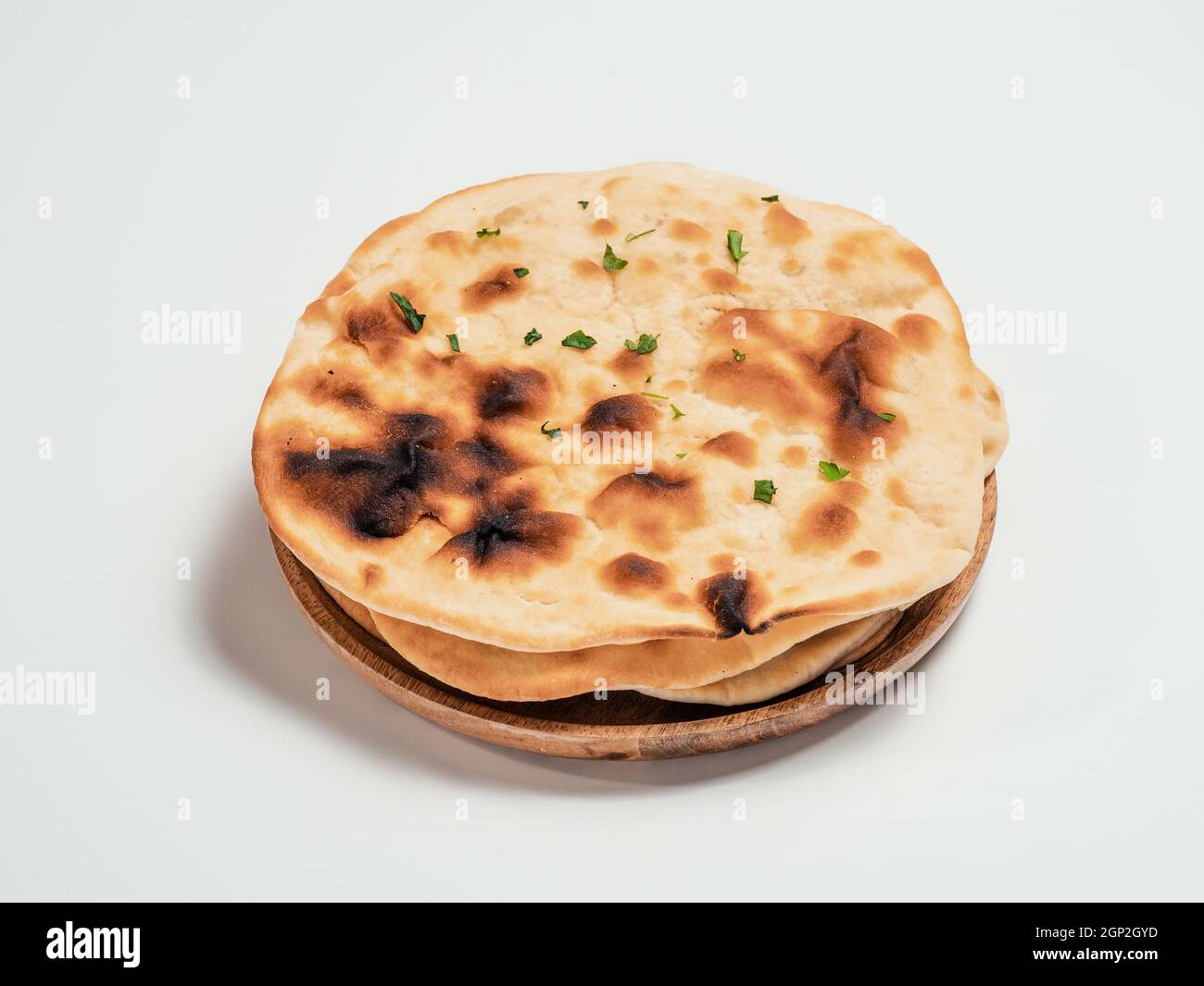 Fresh naan bread on plate isolated on white background. Stack of ...