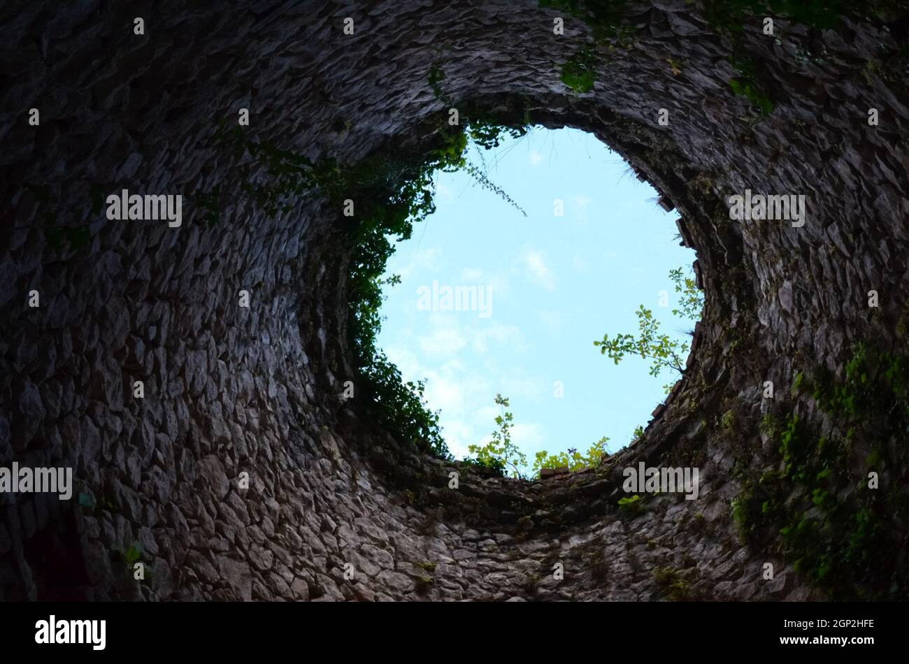 View from the water well from the bottom up. The stone walls of the ...