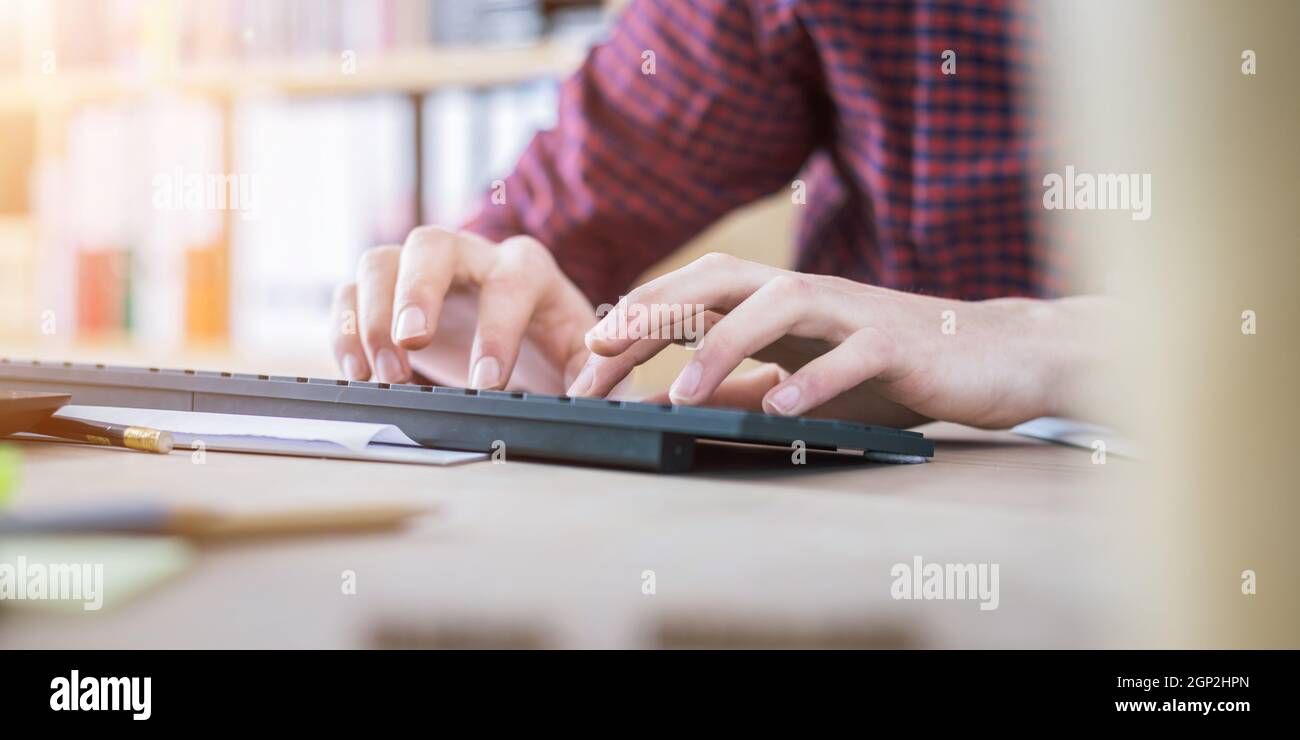 Typing hands on keyboard, home office with text space Stock Photo - Alamy
