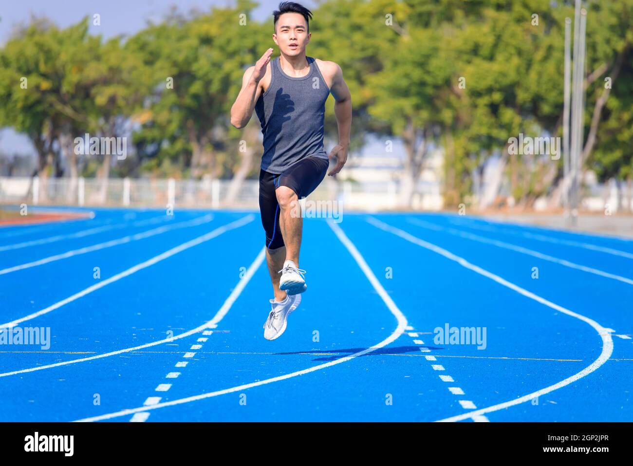 young asian man athlete running and training on the track Stock Photo ...