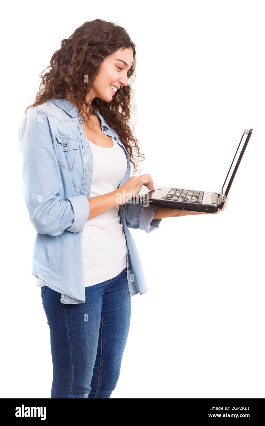 Young student working with her laptop, isolated over a white background ...