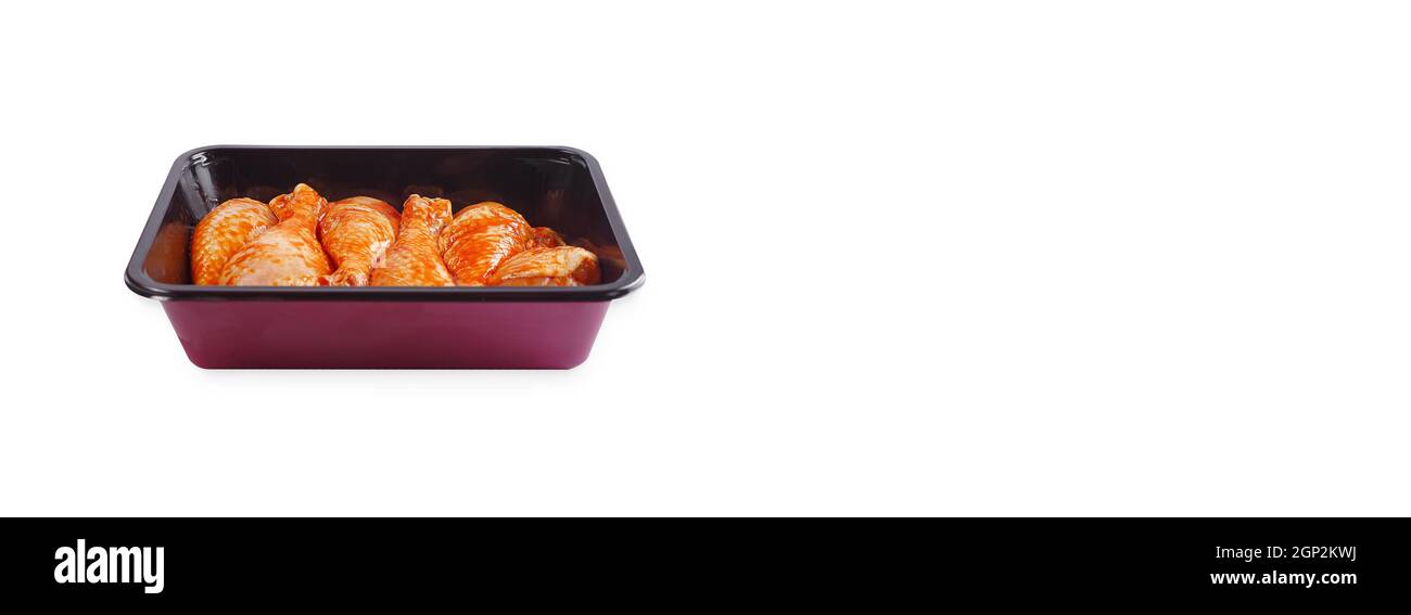 Marinated chicken dramstick in tray for supermarket on white isolated ...