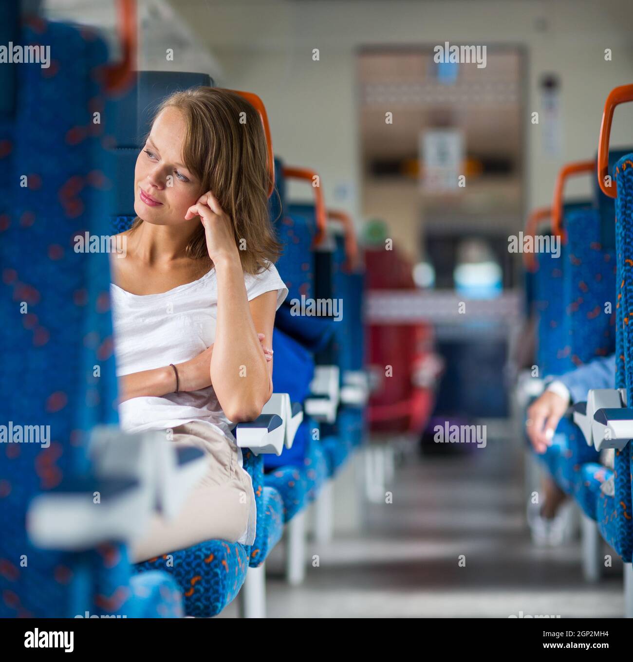 Young woman sitting in the train after a day of work . Train passenger ...