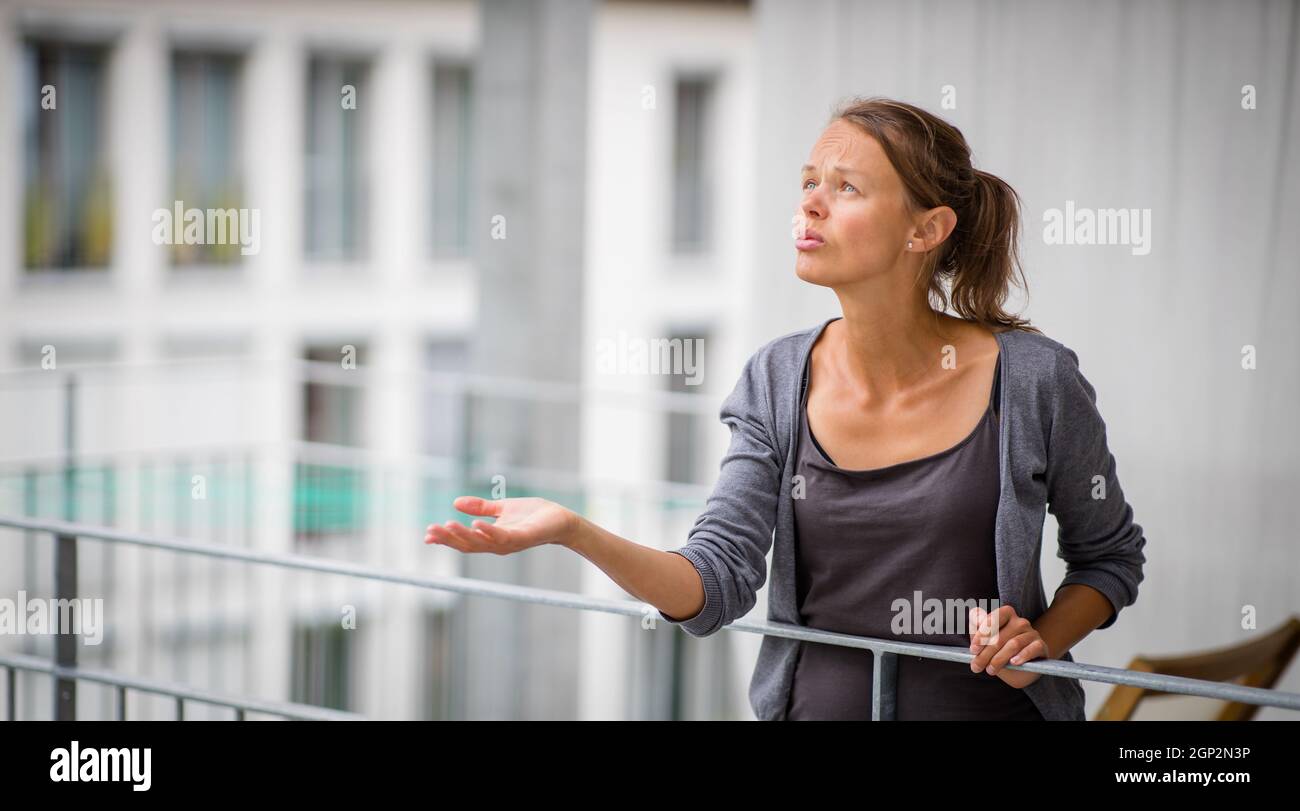 Is it going to rain? No, it is raining already. Young woman checking ...