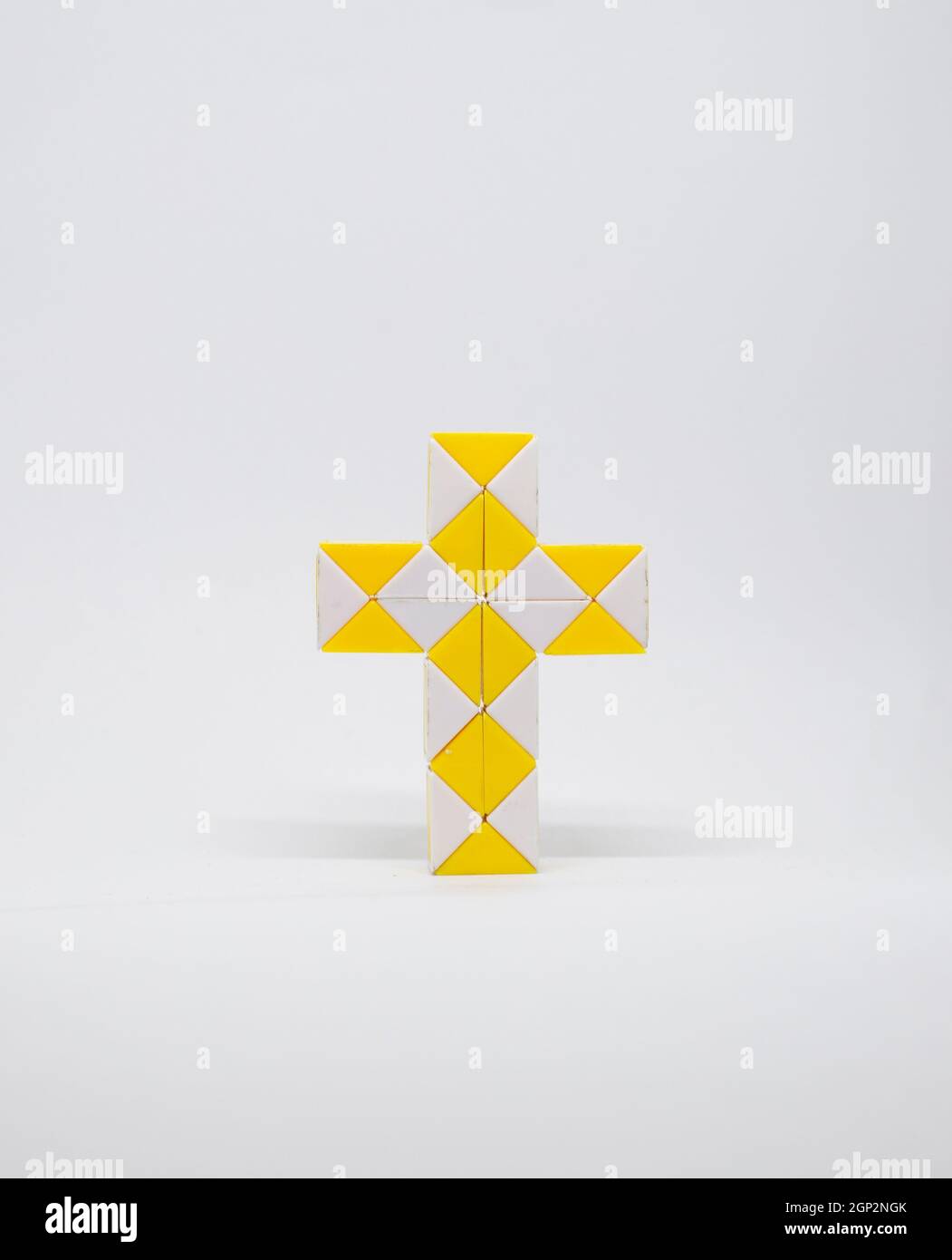 Cross made of yellow and white triangles on a white background Stock ...