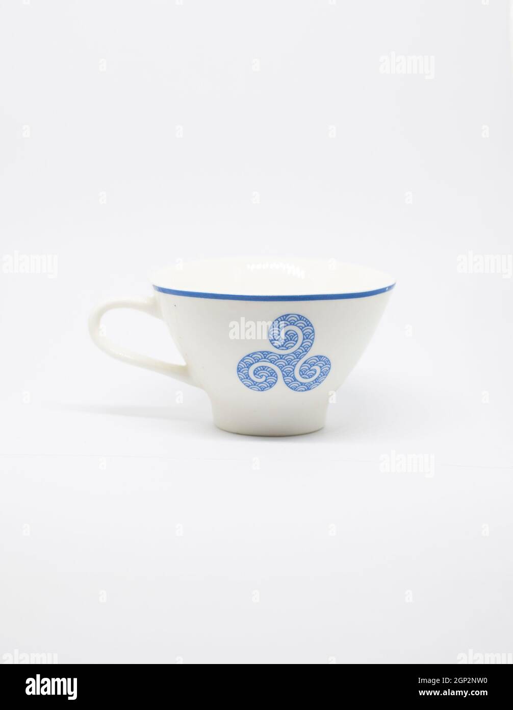 white and blue cup with a blue breton pattern on a white background ...